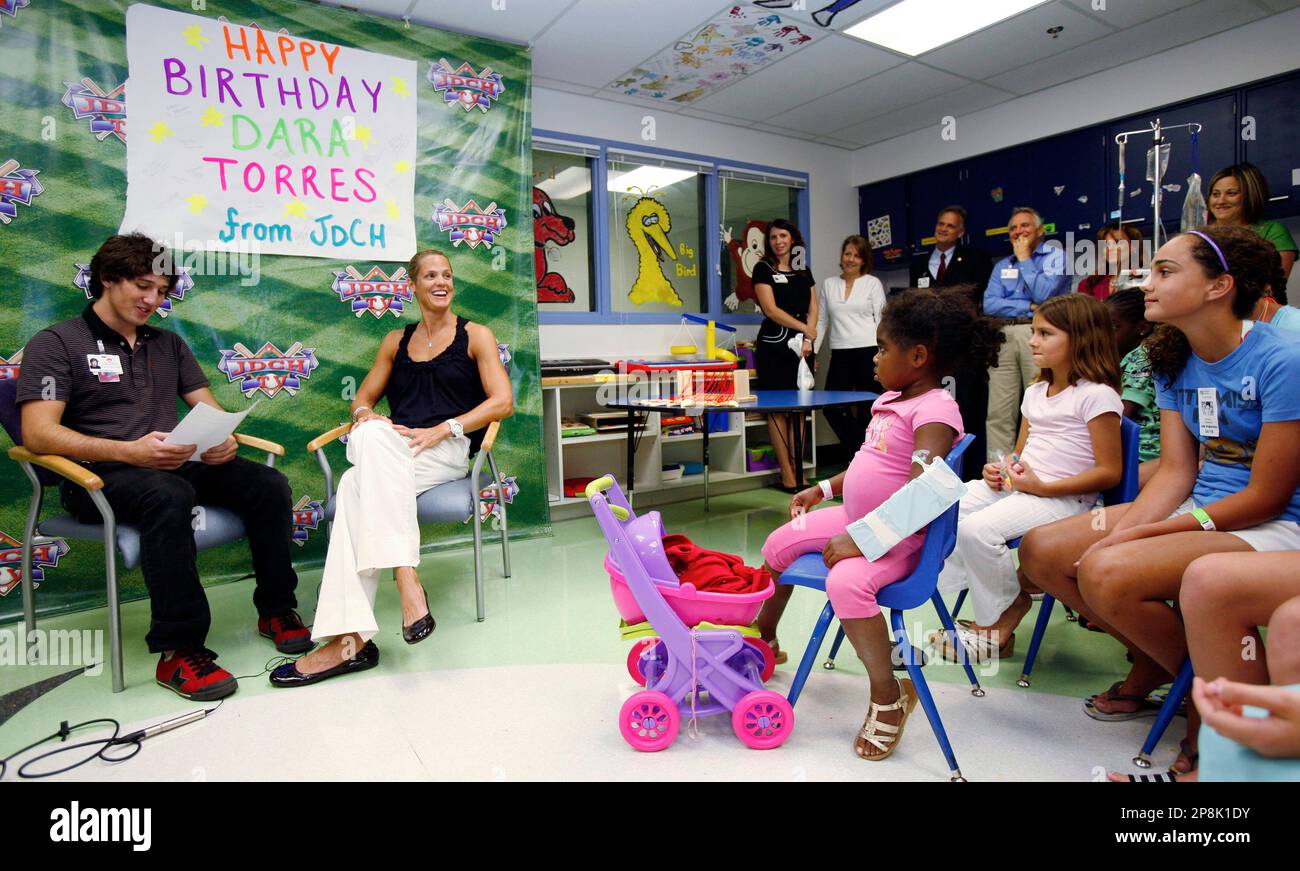 Olympic swimmer Dara Torres, second from left, smiles to the crowd as ...