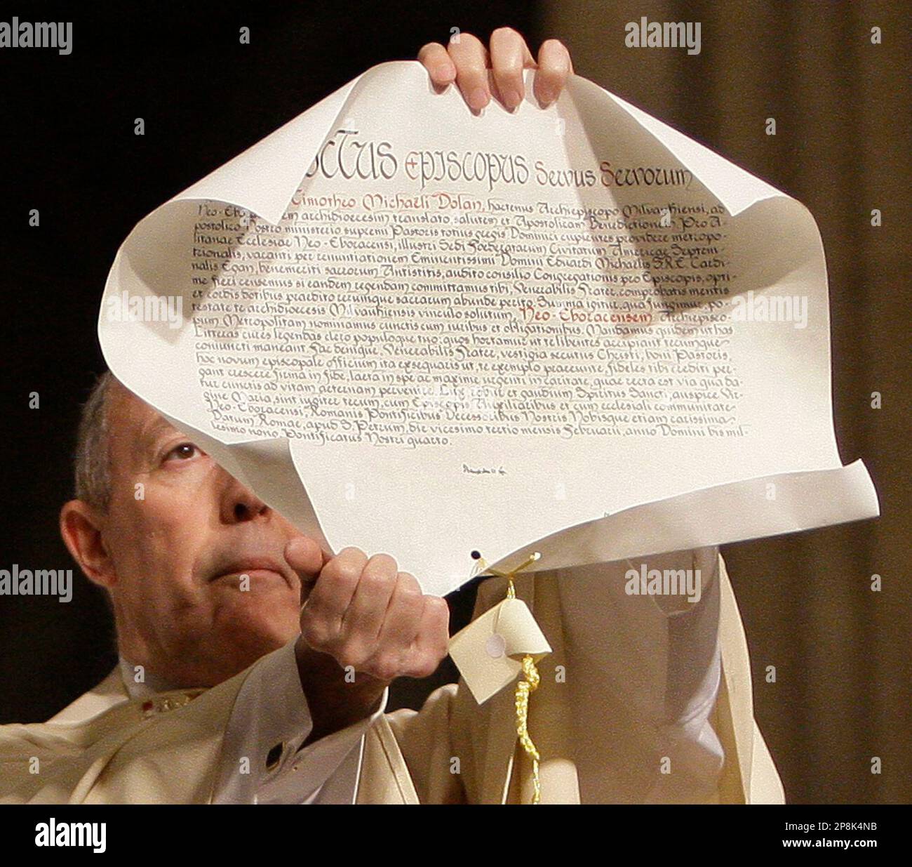 Monsignor William Bedford holds aloft the Apostolic letter from Pope ...