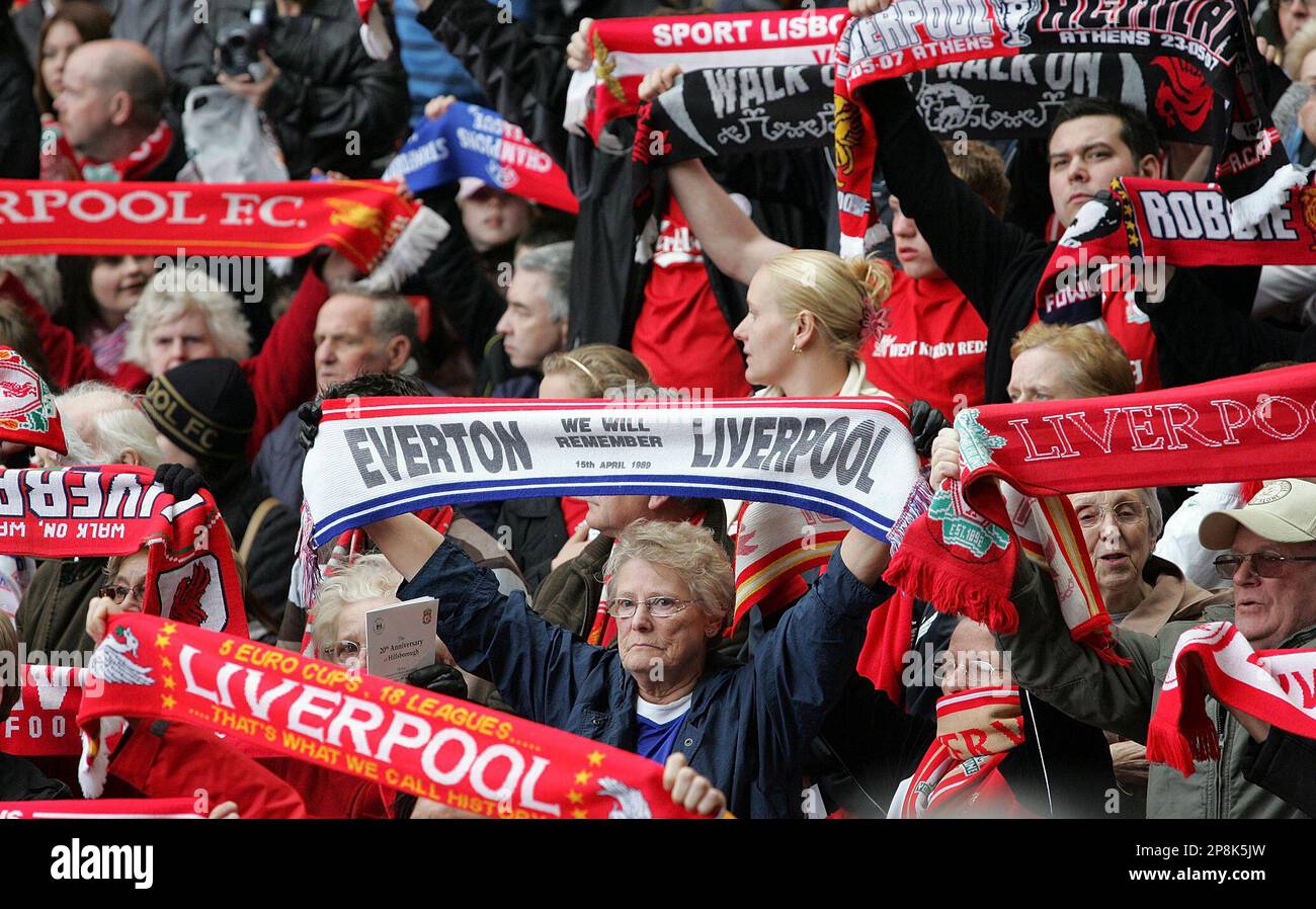 Soccer fans hold up scarves during a memorial to mark the 20th ...