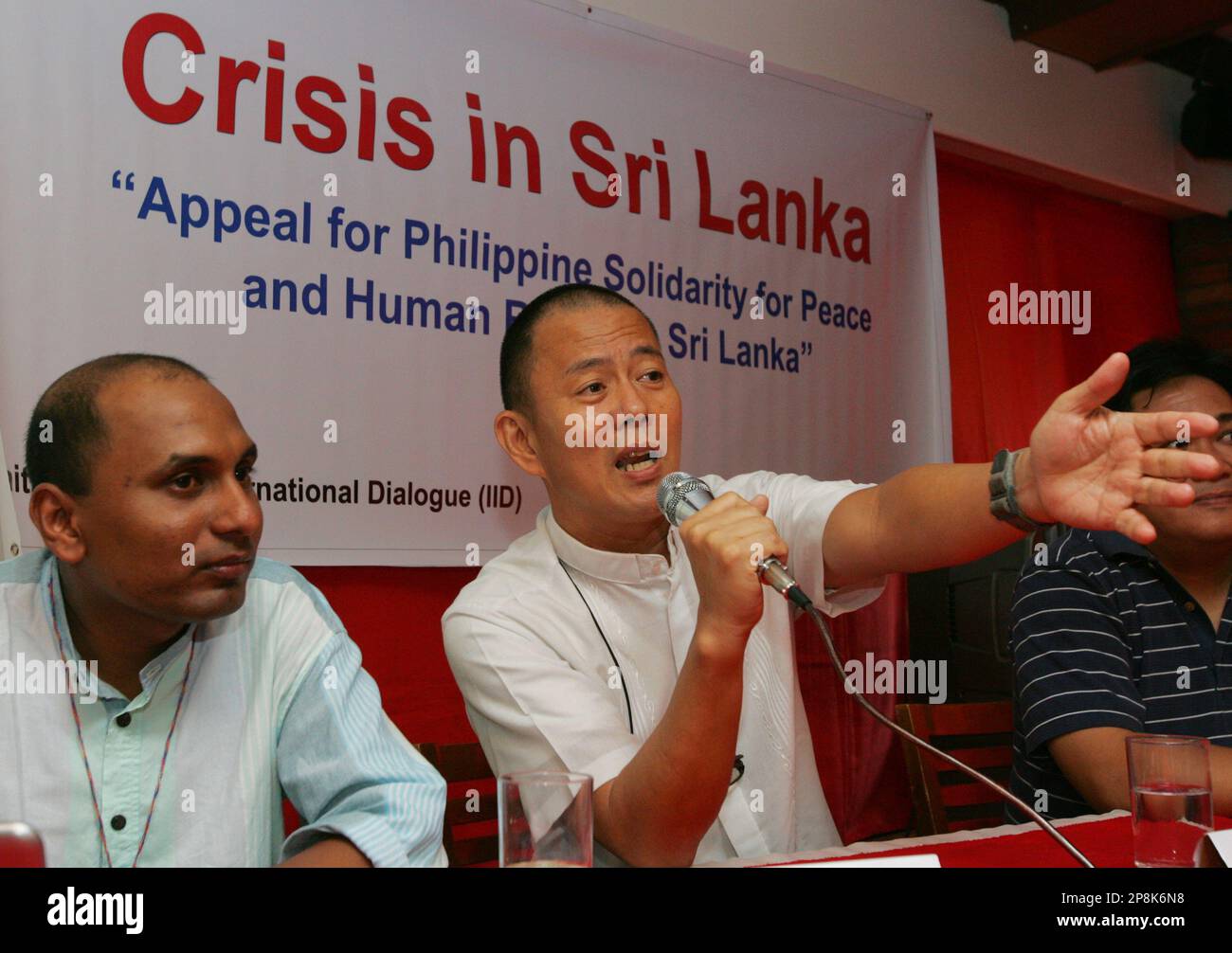Filipino priest Father Robert Reyes gestures during a press conference ...