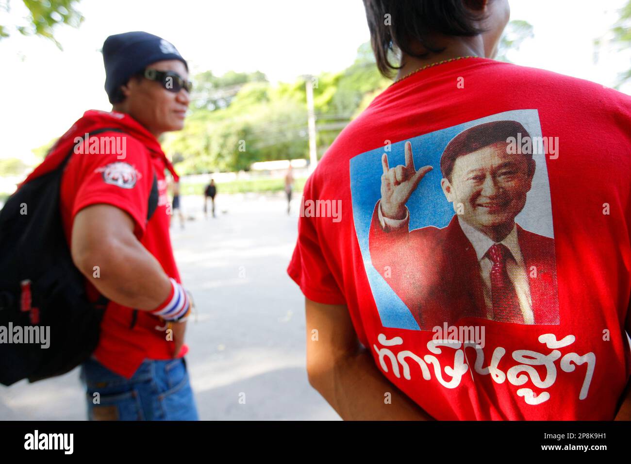 Supporters of ousted Thai Prime Minister Thaksin Shinawatra, shown in a photo printed on a shirt ...