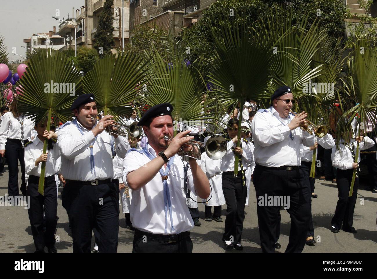 Syrian Catholic devotees hold up lights and candles during the ...