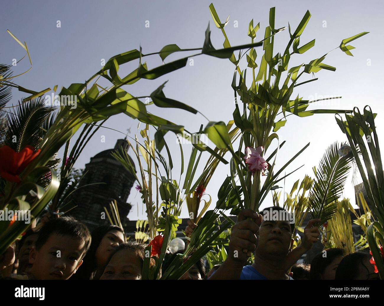 Filipino devotees wave palm fronds during Palm Sunday rites, April 5 ...
