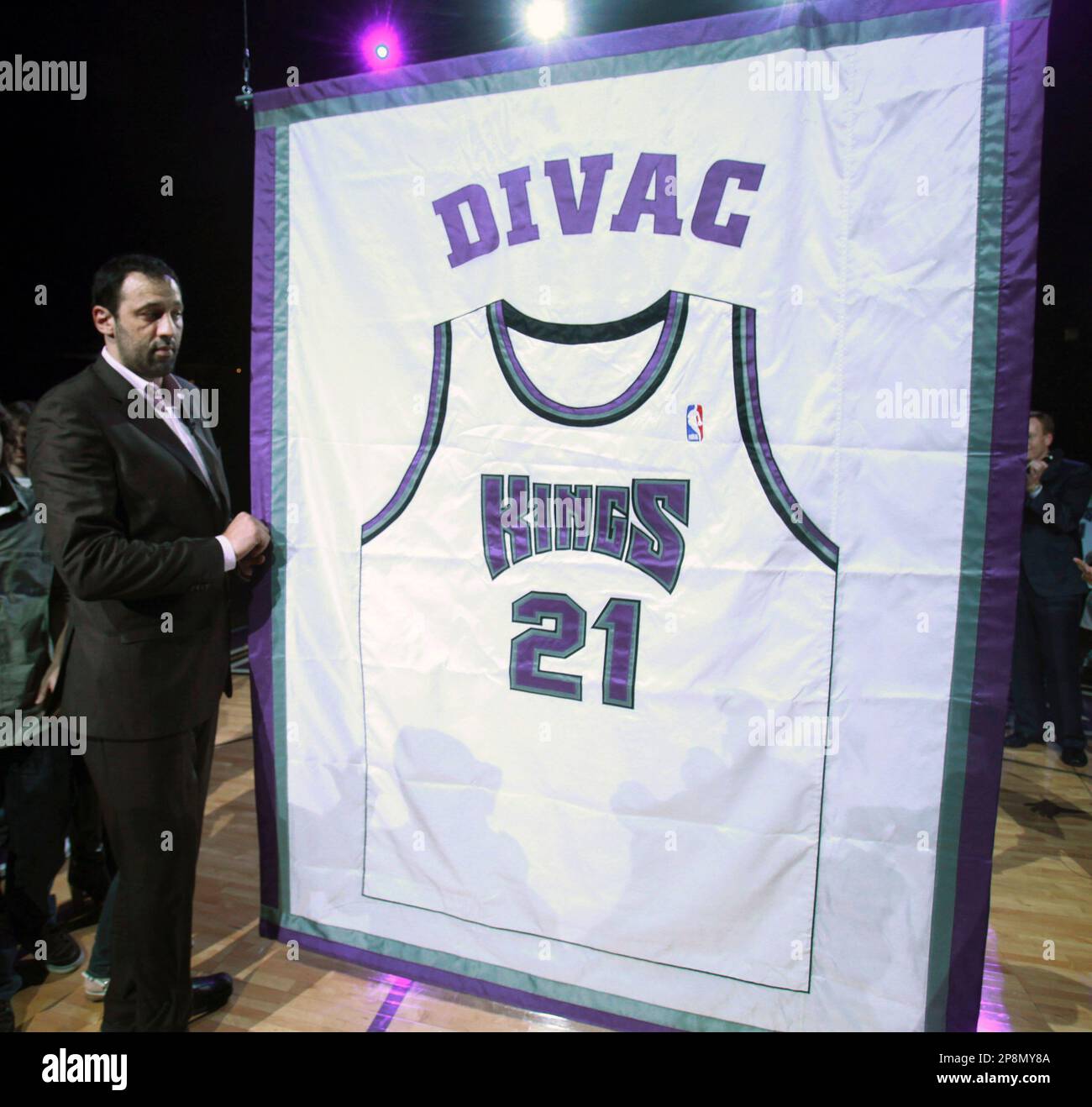 Former Sacramento Kings center Vlade Divac, of Serbia, stands next to a ...