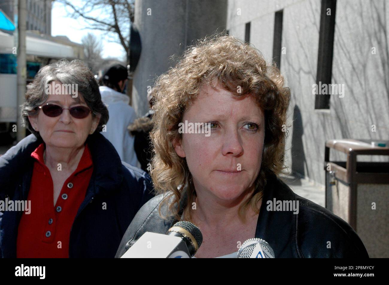 Anne Rossi, center, talks to reporters accompanied by her mother ...