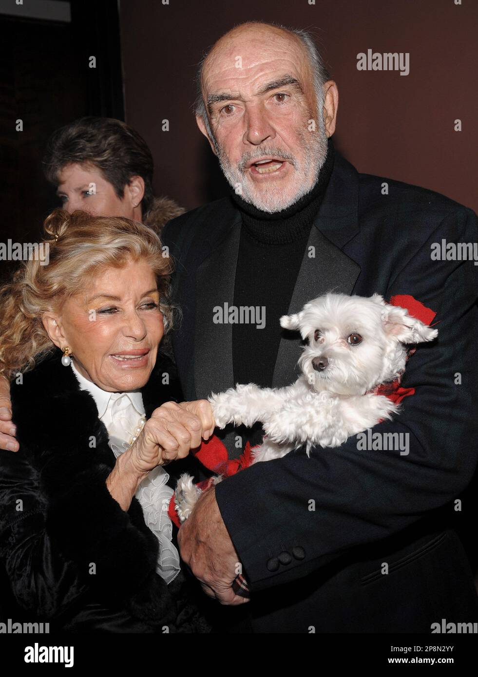 Sir Sean Connery and wife Lady Micheline holding a dog dressed in a ...