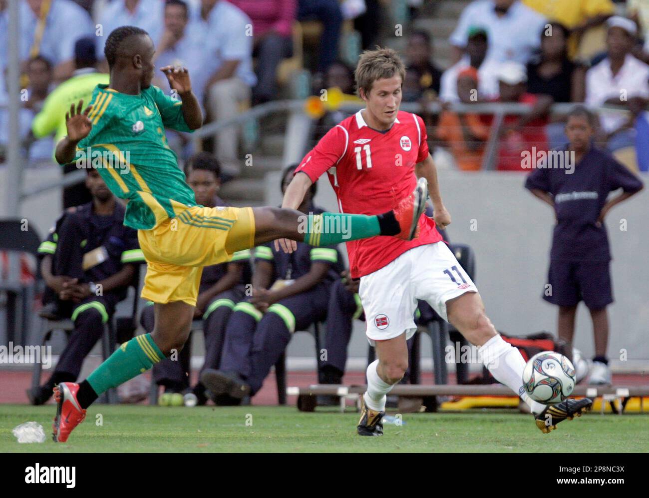 Norway's Morten Gamst Pedersen, right, passes the ball as South Africa ...