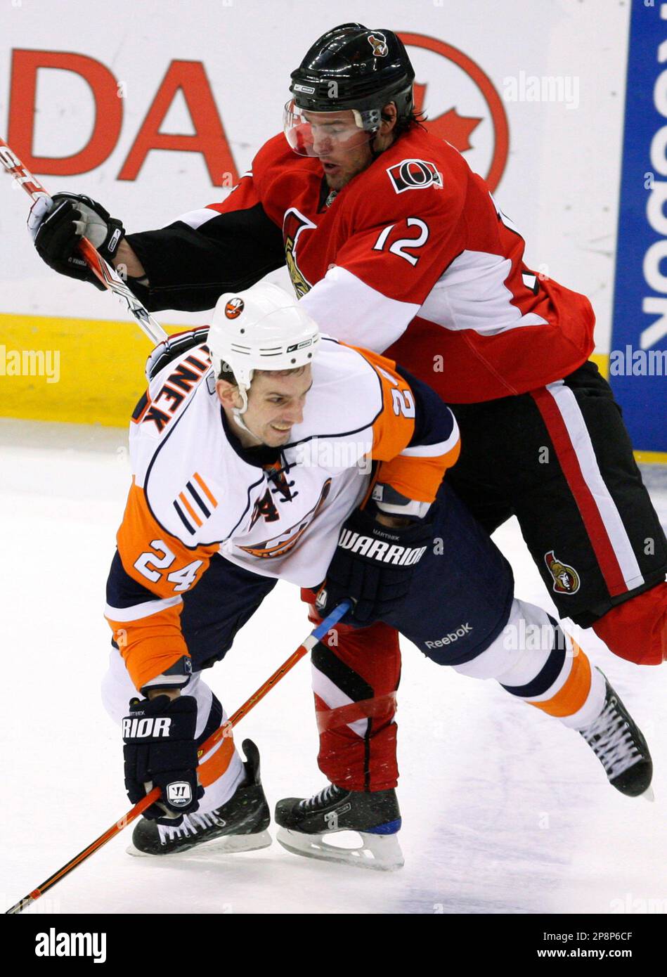 Ottawa Senators' Mike Fisher (12) checks New York Islanders' Radnek ...