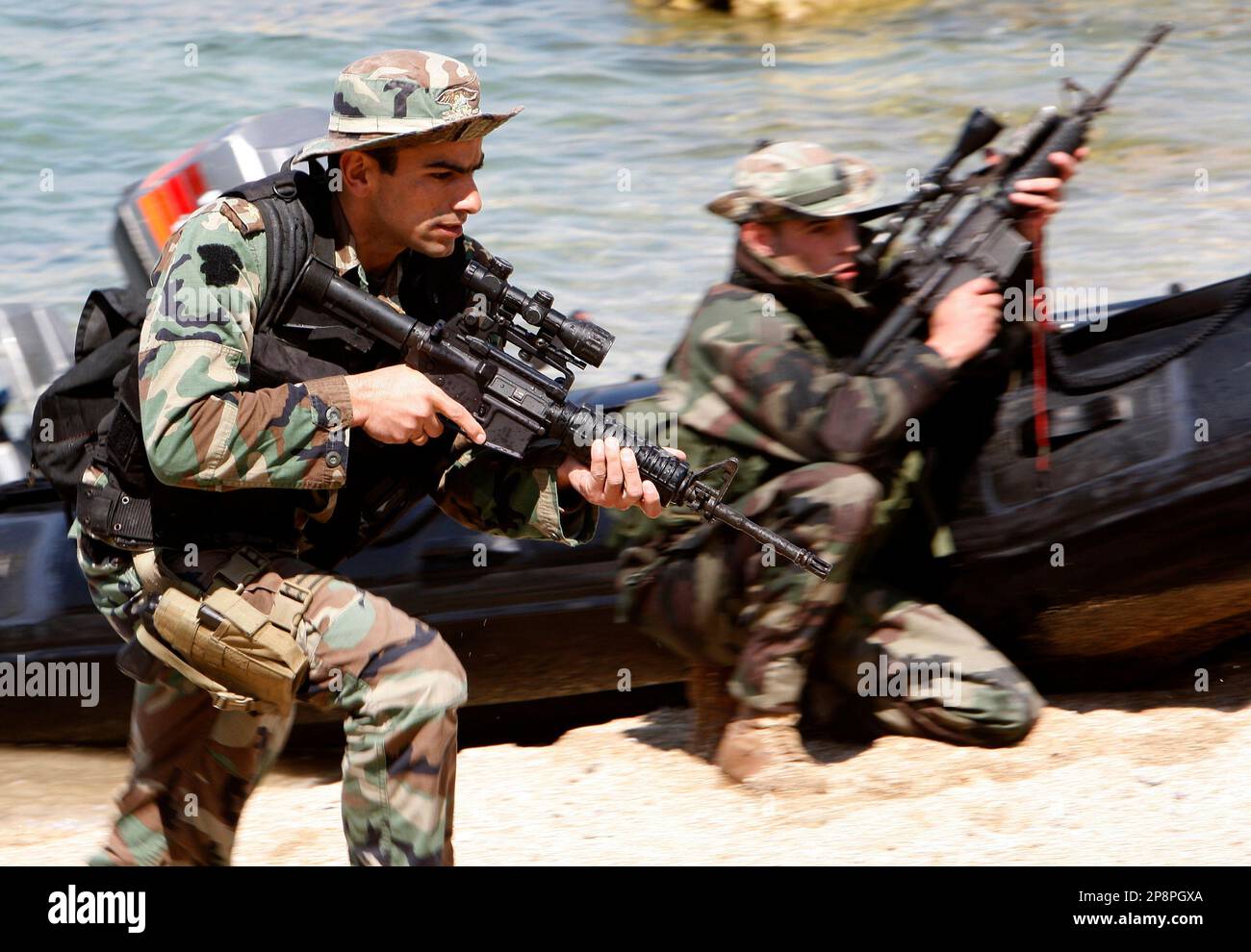 A Lebanese marine special forces soldier, runs to take his position ...