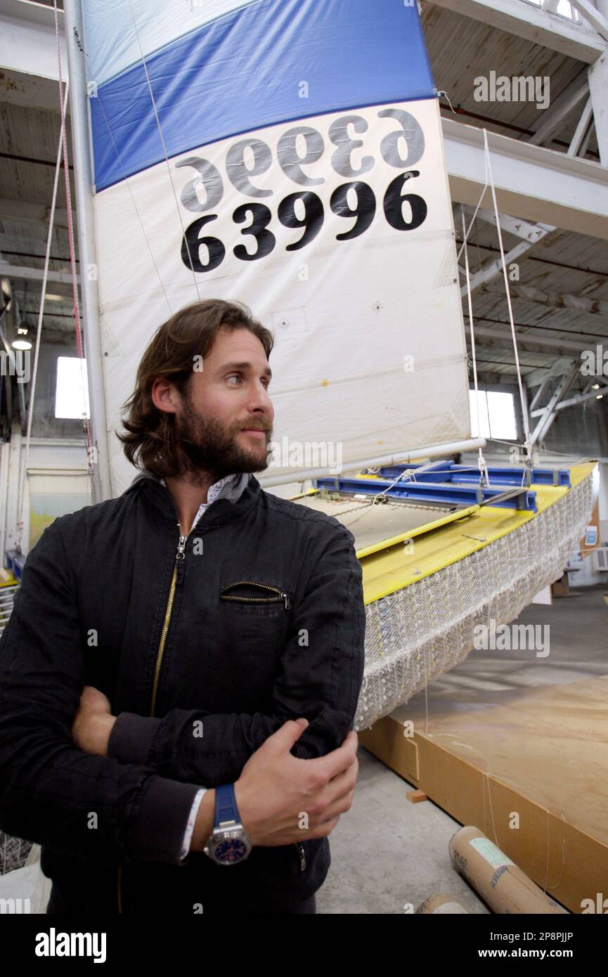 British environmentalist David de Rothschild stands beside a one third ...
