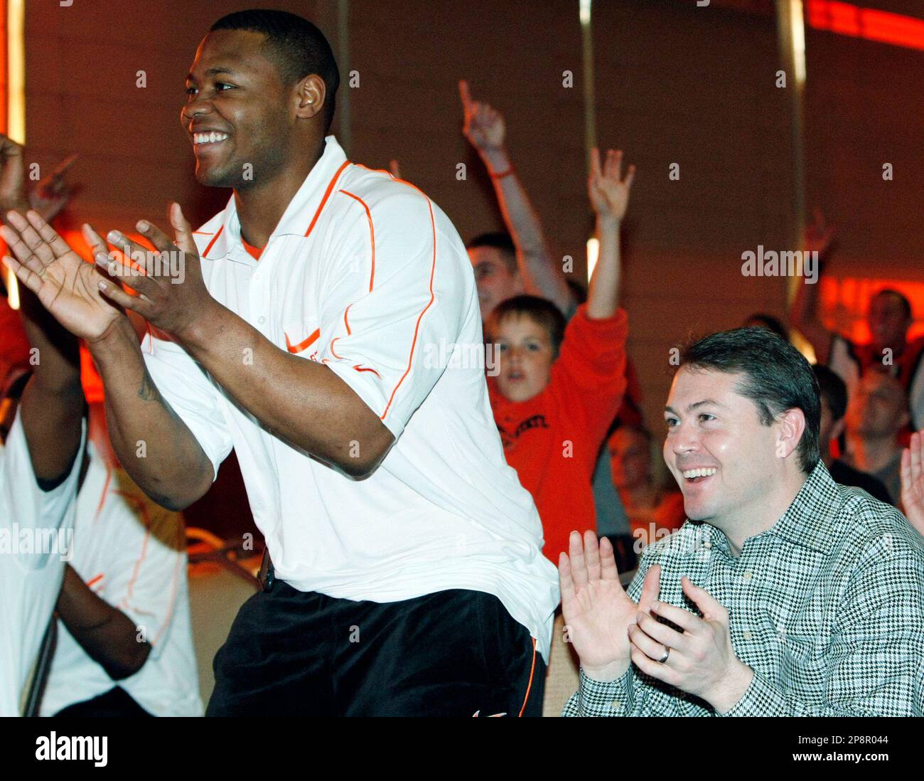 Oklahoma State guard Byron Eaton, left, hops out of his seat, and head ...