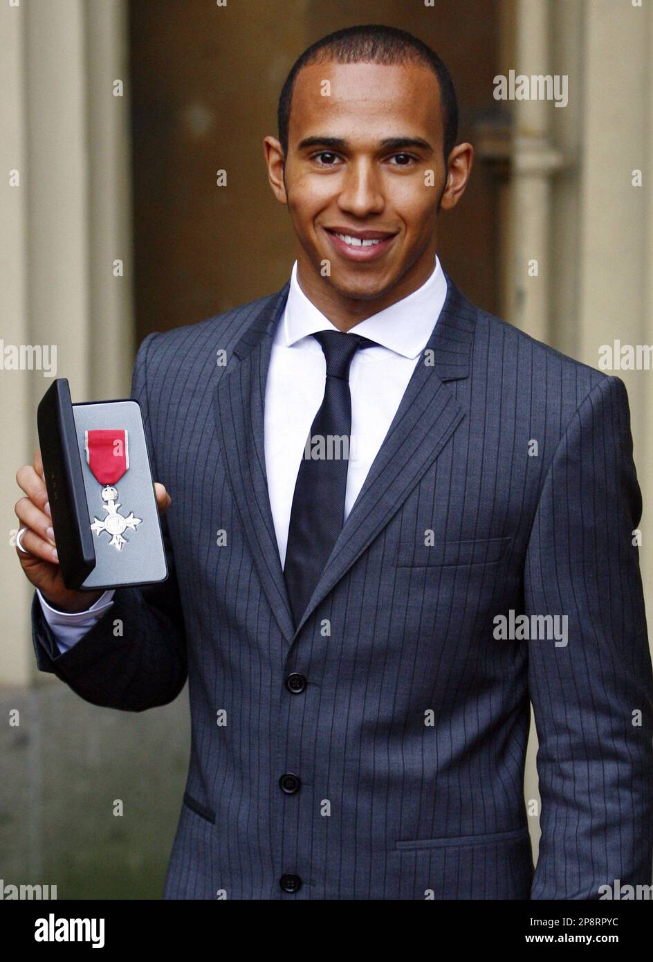 Formula One world champion Lewis Hamilton poses with in insignia of the ...