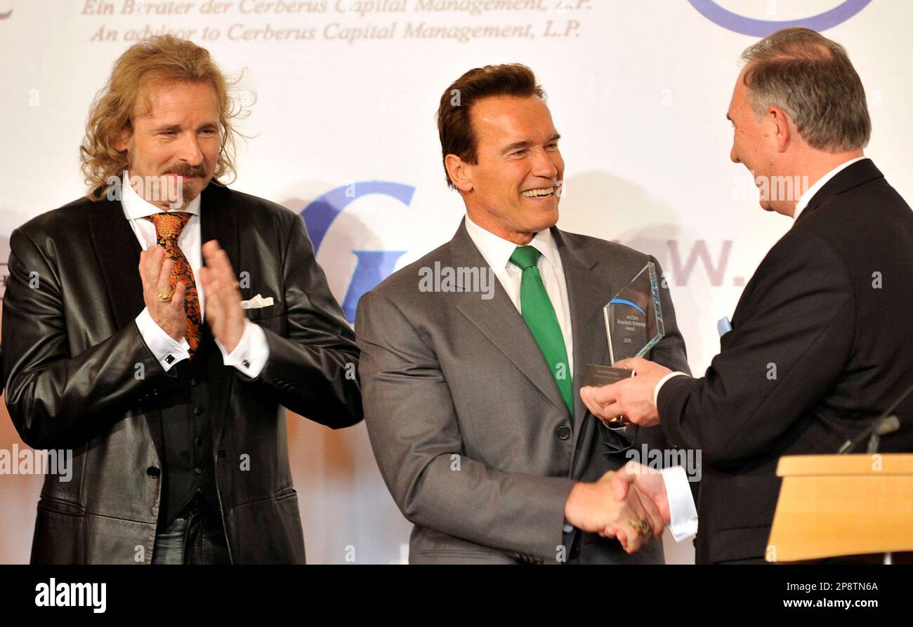 Fred B. Irwin, president of AmCham Germany, right, hands over the ...