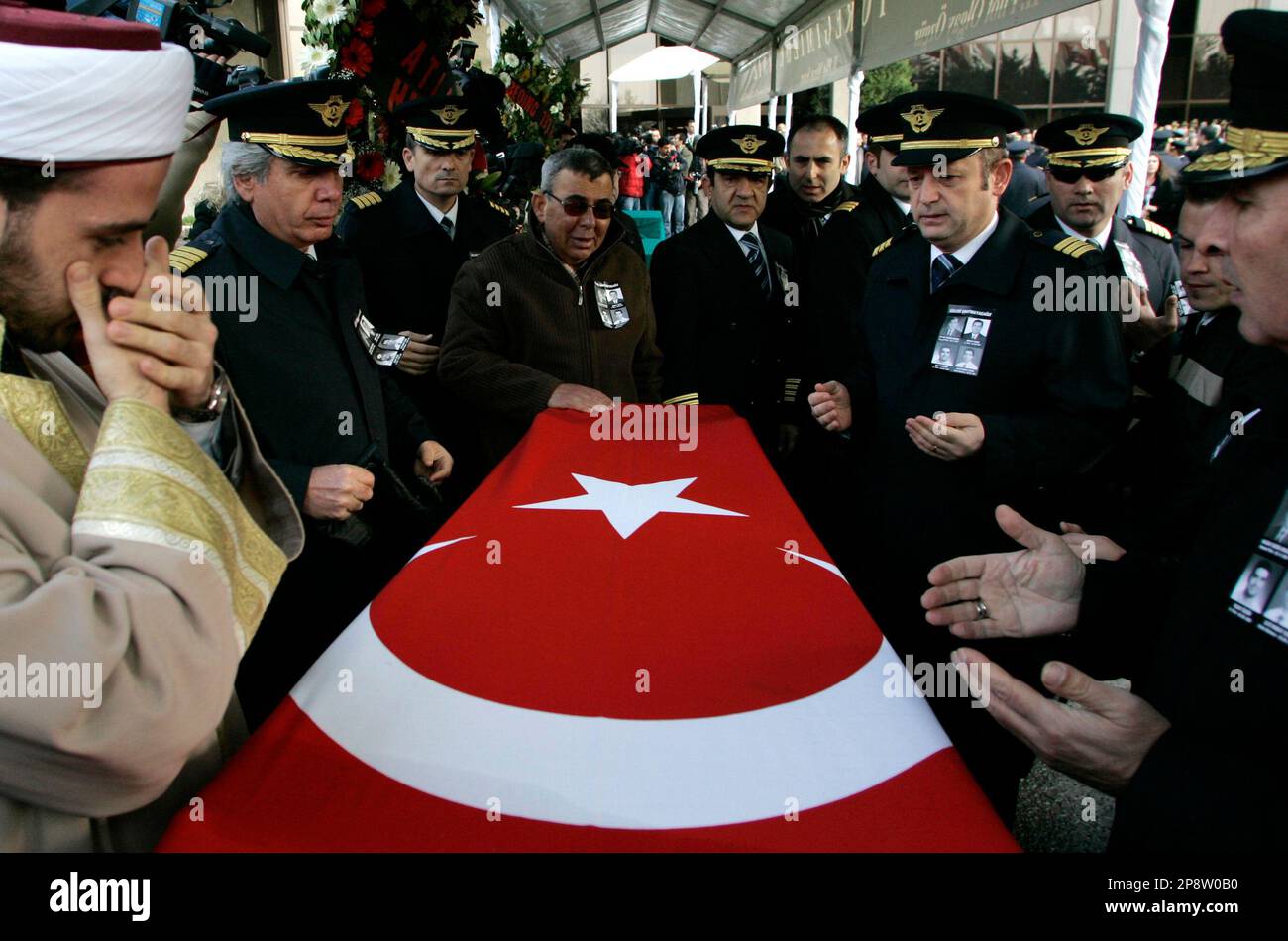 Turkish pilots pray next to the flag-wrapped coffin of their colleague ...