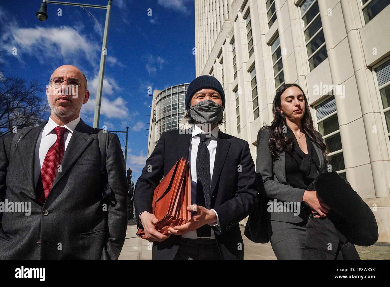 Roger Ng, center, a former Goldman Sachs banker, leaves federal court ...