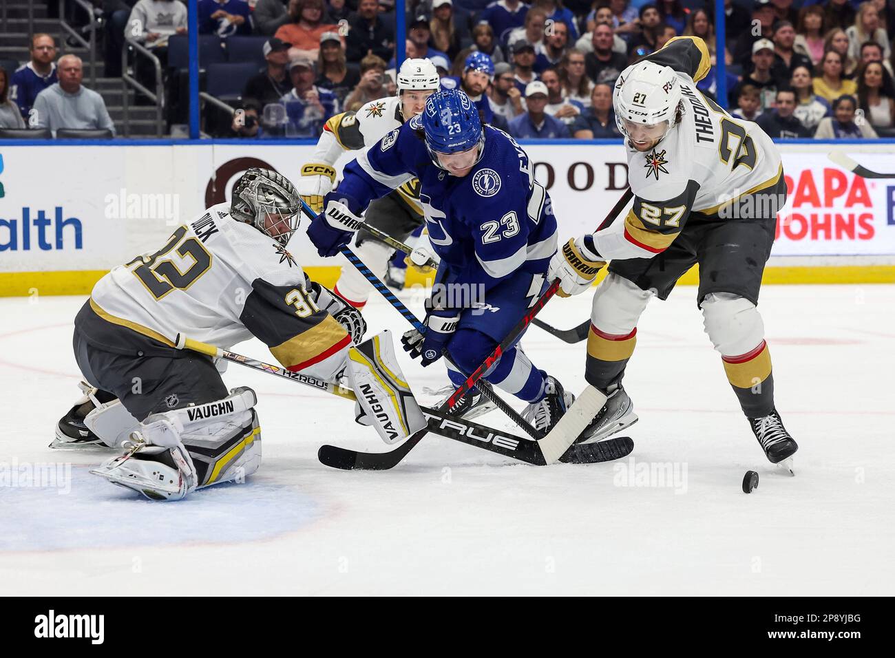 Vegas Golden Knights' Shea Theodore (27) checks Tampa Bay Lightning's ...