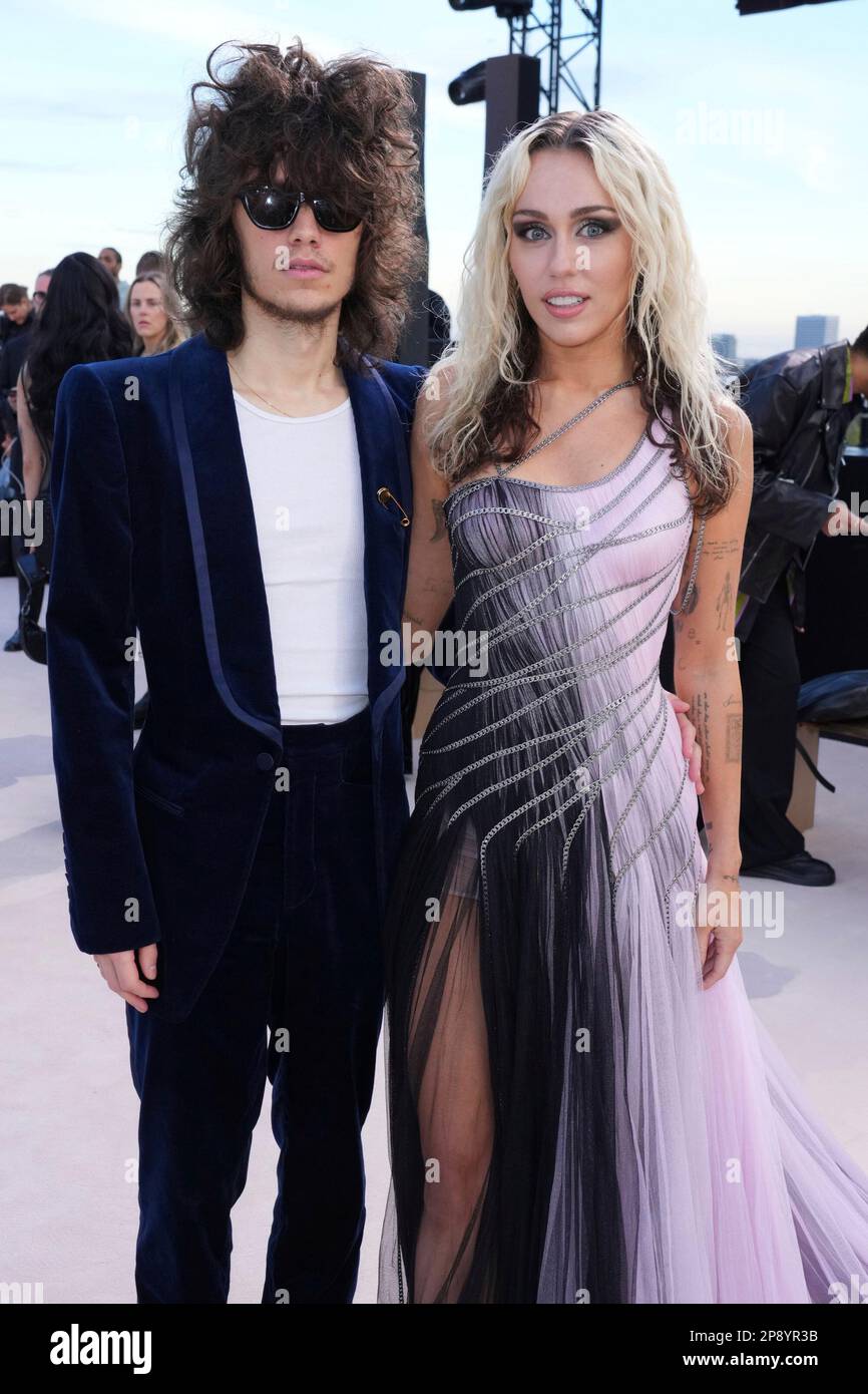 Miley Cyrus, right, and Maxx Morando attend the Versace Fall/Winter ...