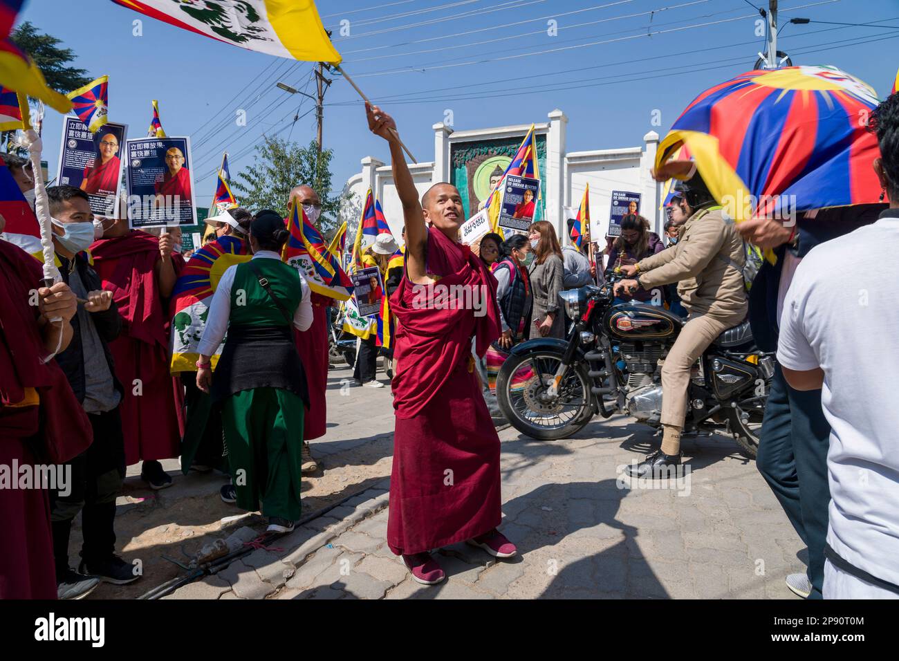 An exile Tibetan Buddhist monk shouts slogans and swings the Tibetan ...