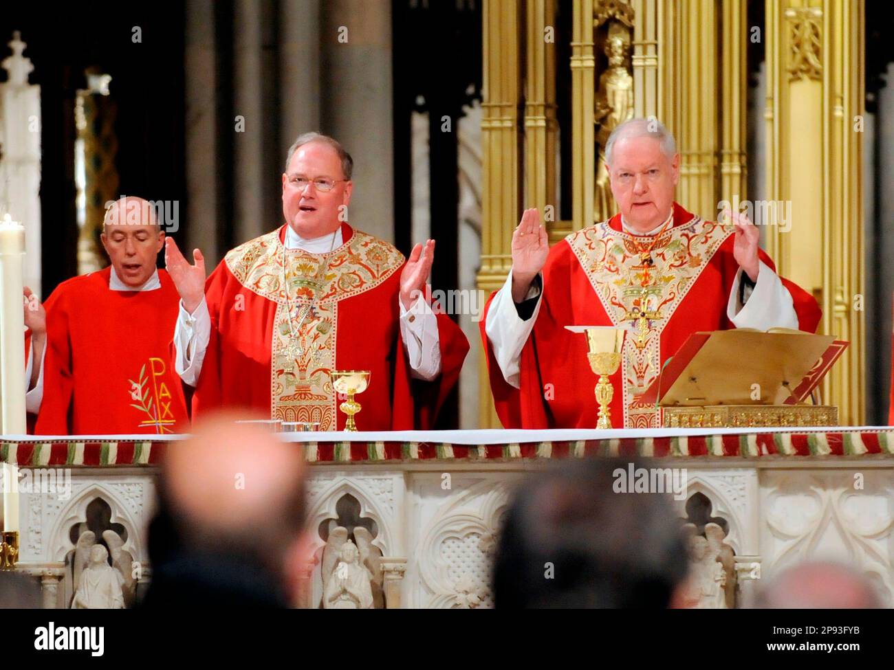 Milwaukee Archbishop Timothy M. Dolan, center, celebrates morning mass ...