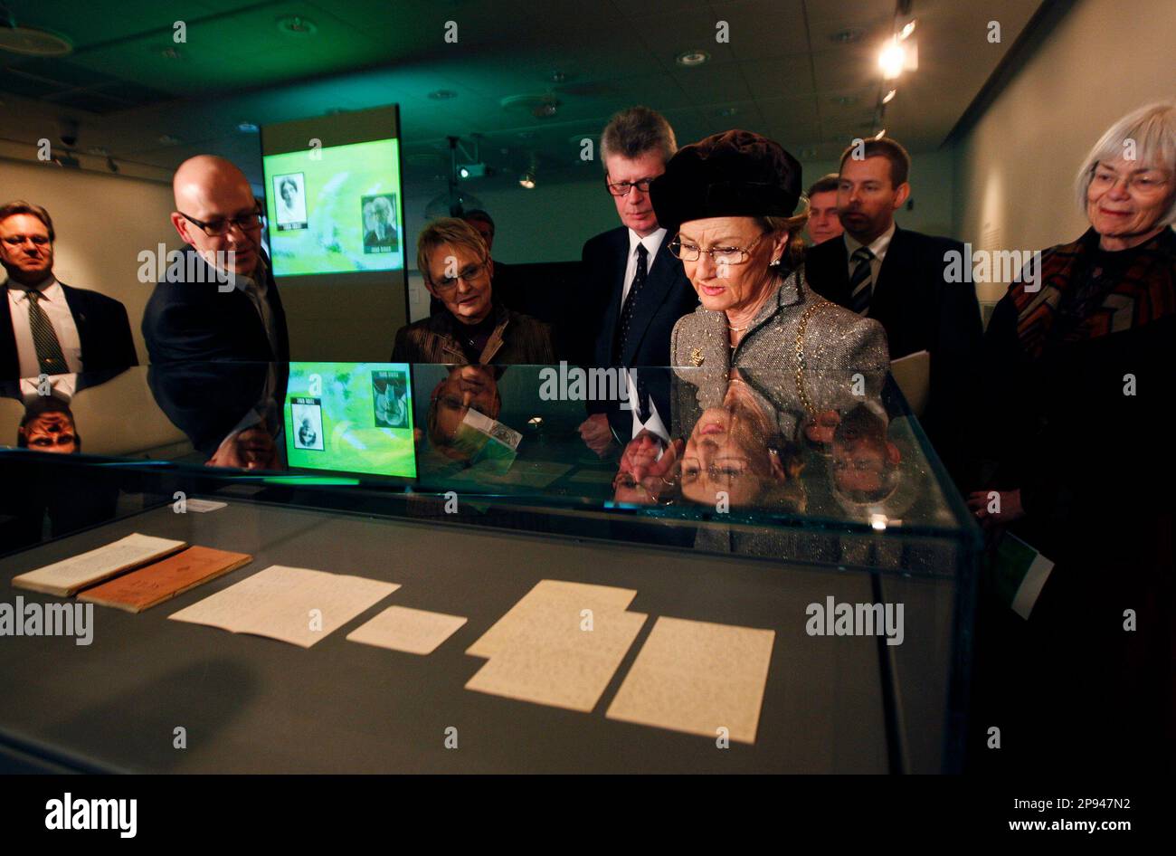 Norwegian Queen Sonja studies part of the original manuscript of Knut ...