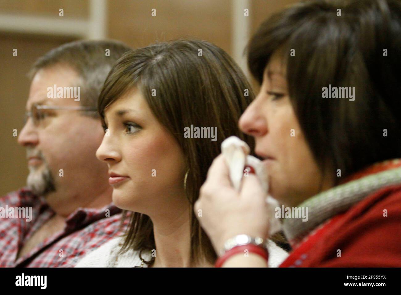 Cindy Sanderholm, right, her daughter Jennifer and husband Brian listen ...
