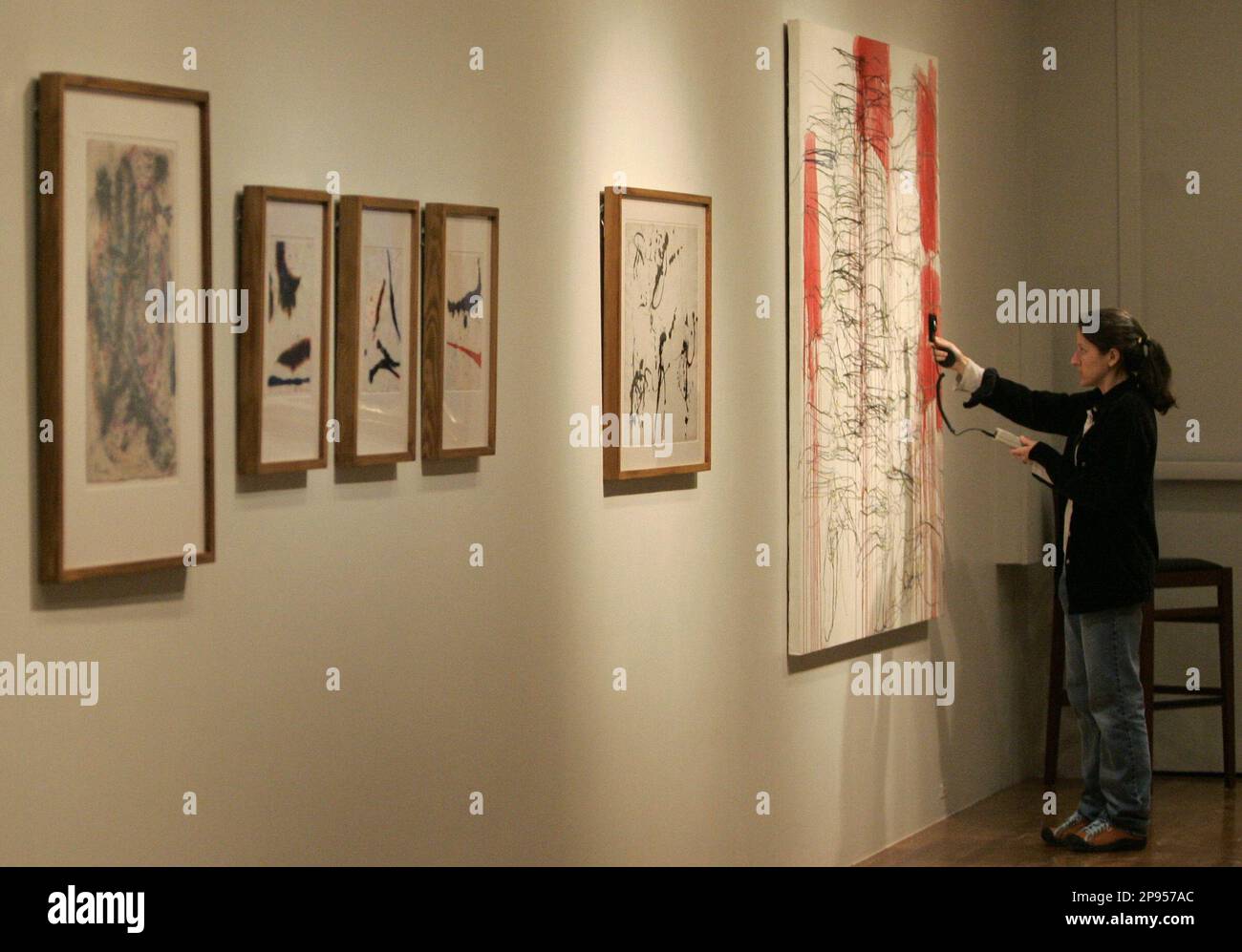 Cincinnati Art Museum employee Jennifer Fenner uses a light meter to ...