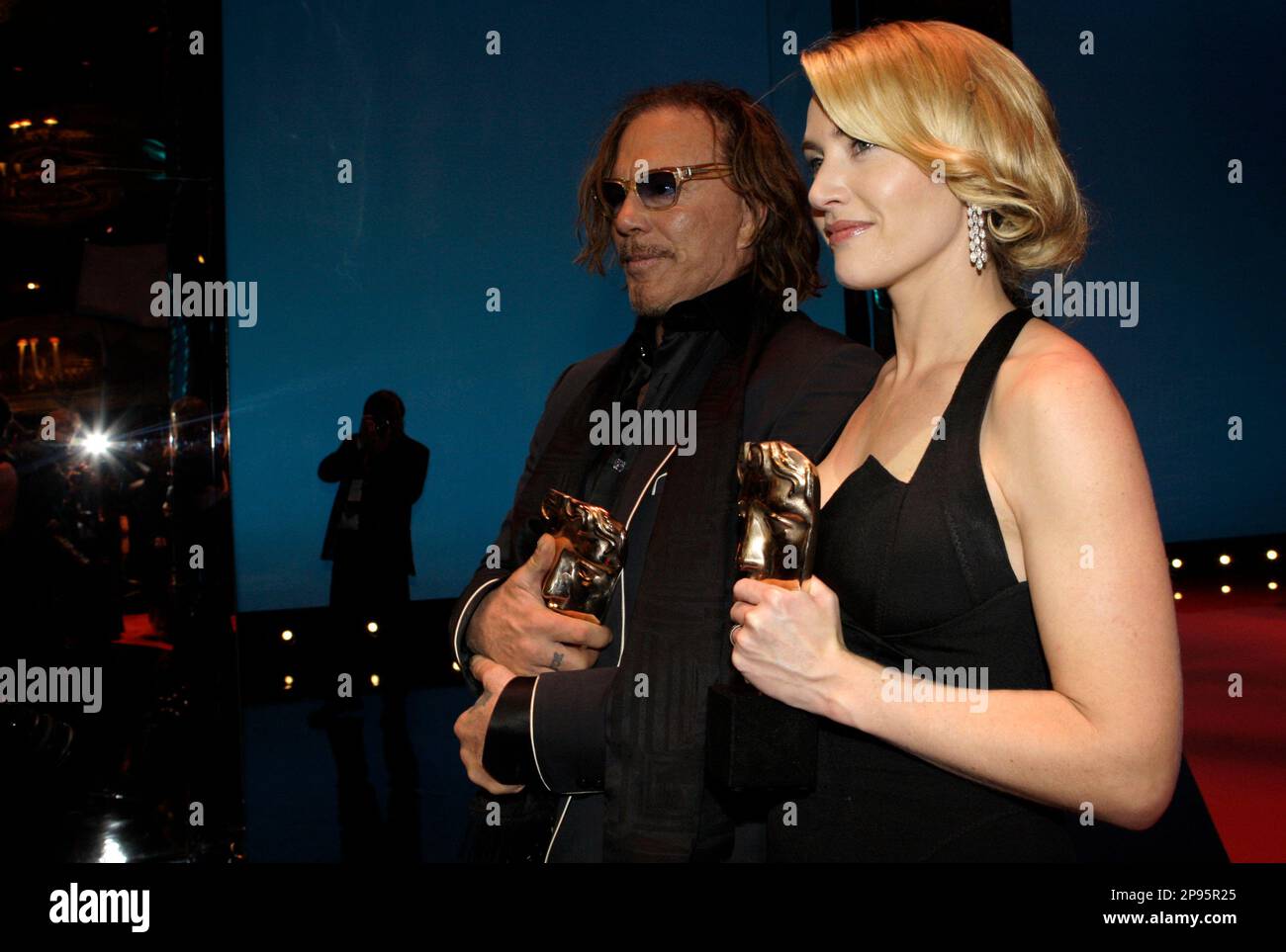 US actor Mickey Rourke, left, with his Best Actor award for his role in ...
