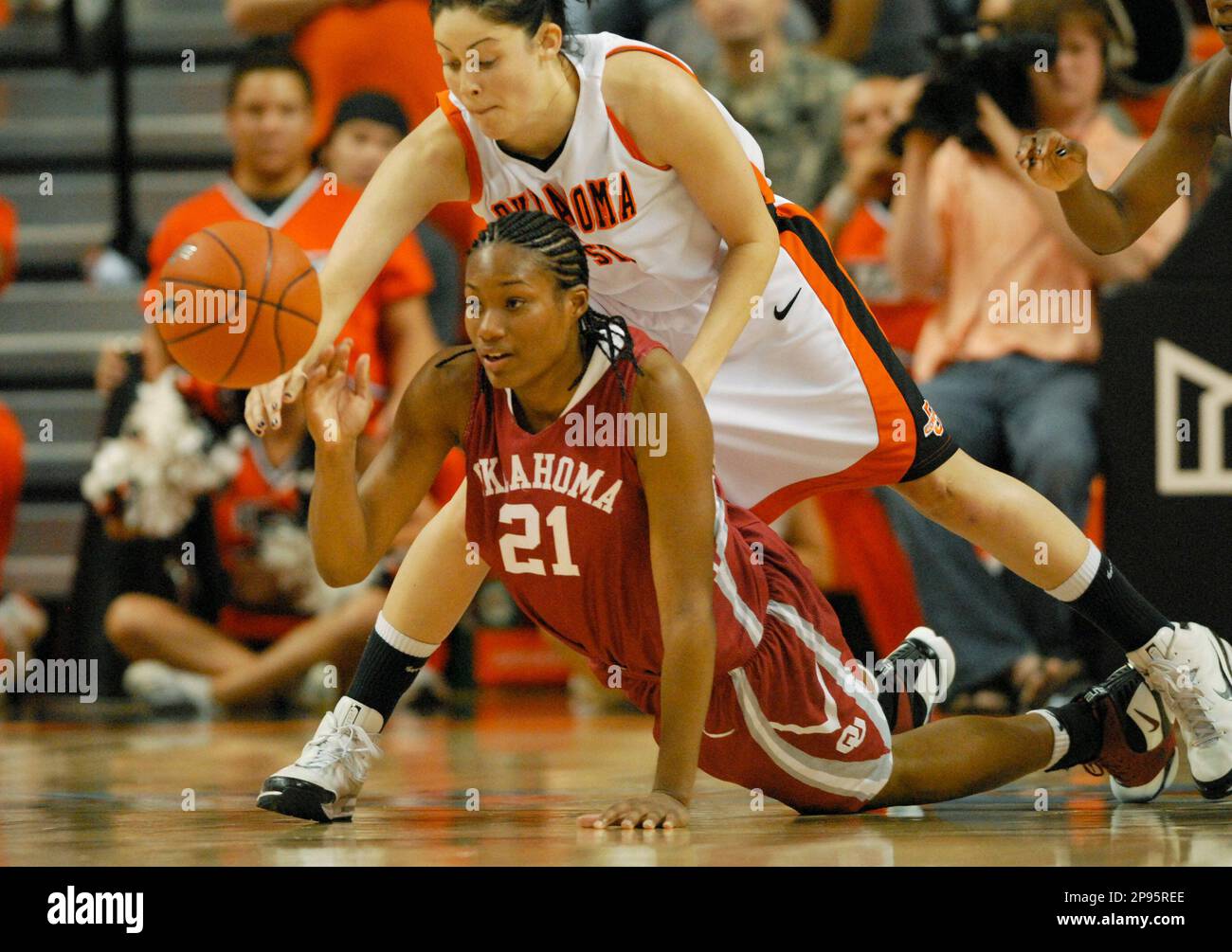 Oklahoma State forward Tegan Cunningham, back, goes after a loose ball ...
