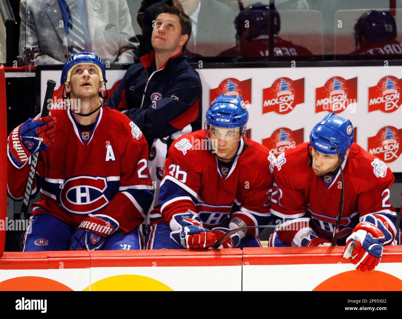 Montreal Canadiens Alex Kovalev, left, of Russia, Matt D'Agostini and Steve Begin, right, watch ...