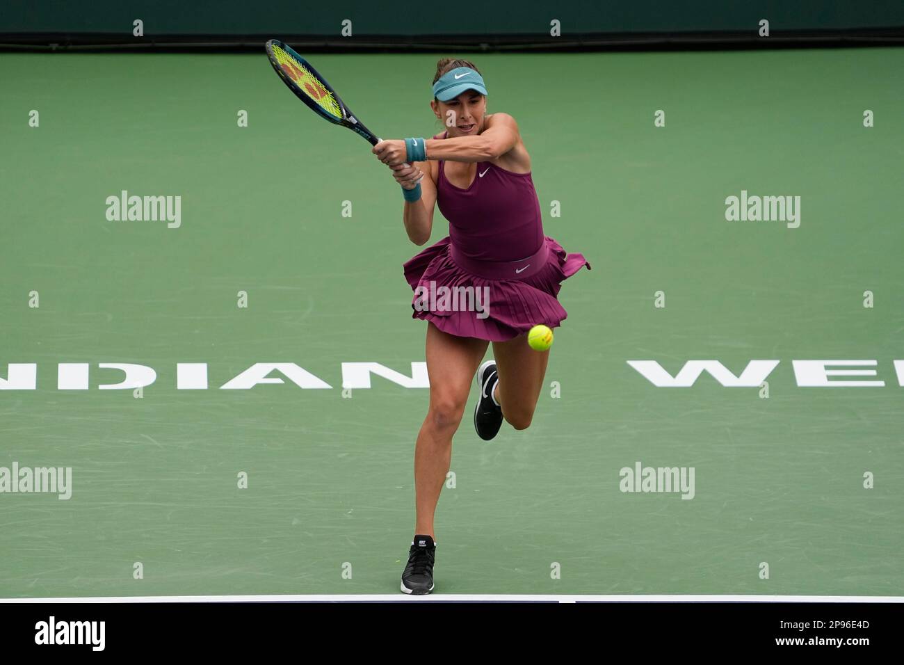 Belinda Bencic, of Switzerland, returns a shot to Jil Teichmann, of ...