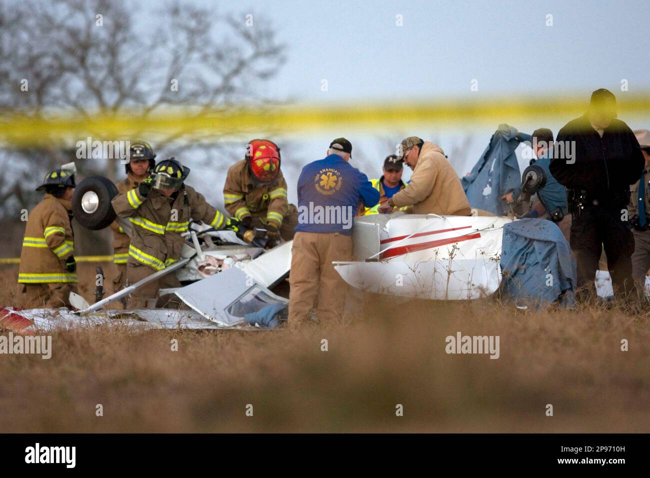 Rescue personnel work to recover three bodies from a small experimental ...