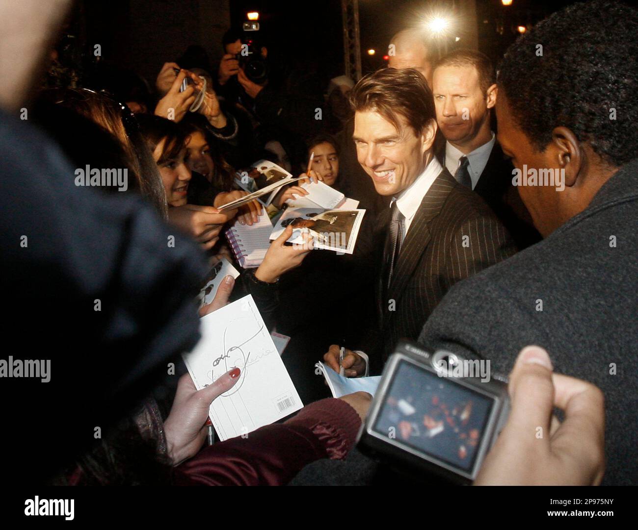 Actor Tom Cruise signs autographs as he arrives for the Italian premier ...