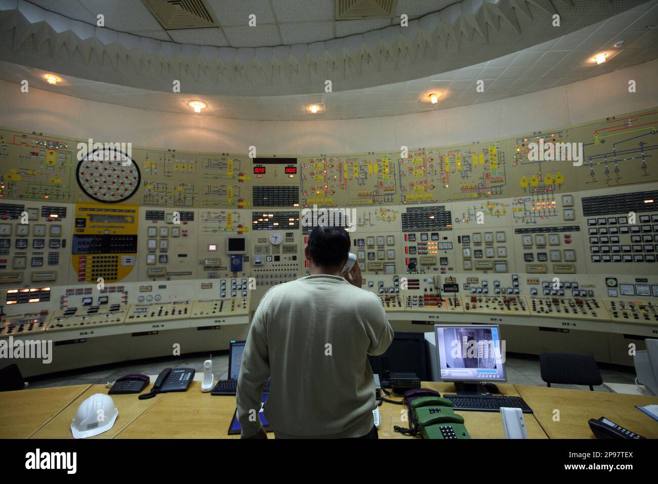 An operator speaks at the phone in the control room of the closed third ...