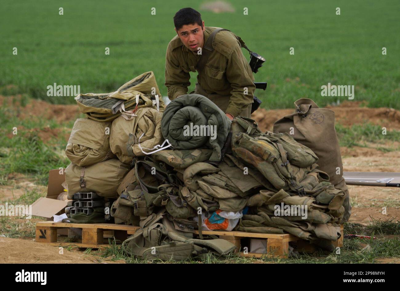 An Israeli soldier packs his belongings at an outpost on the Israeli ...