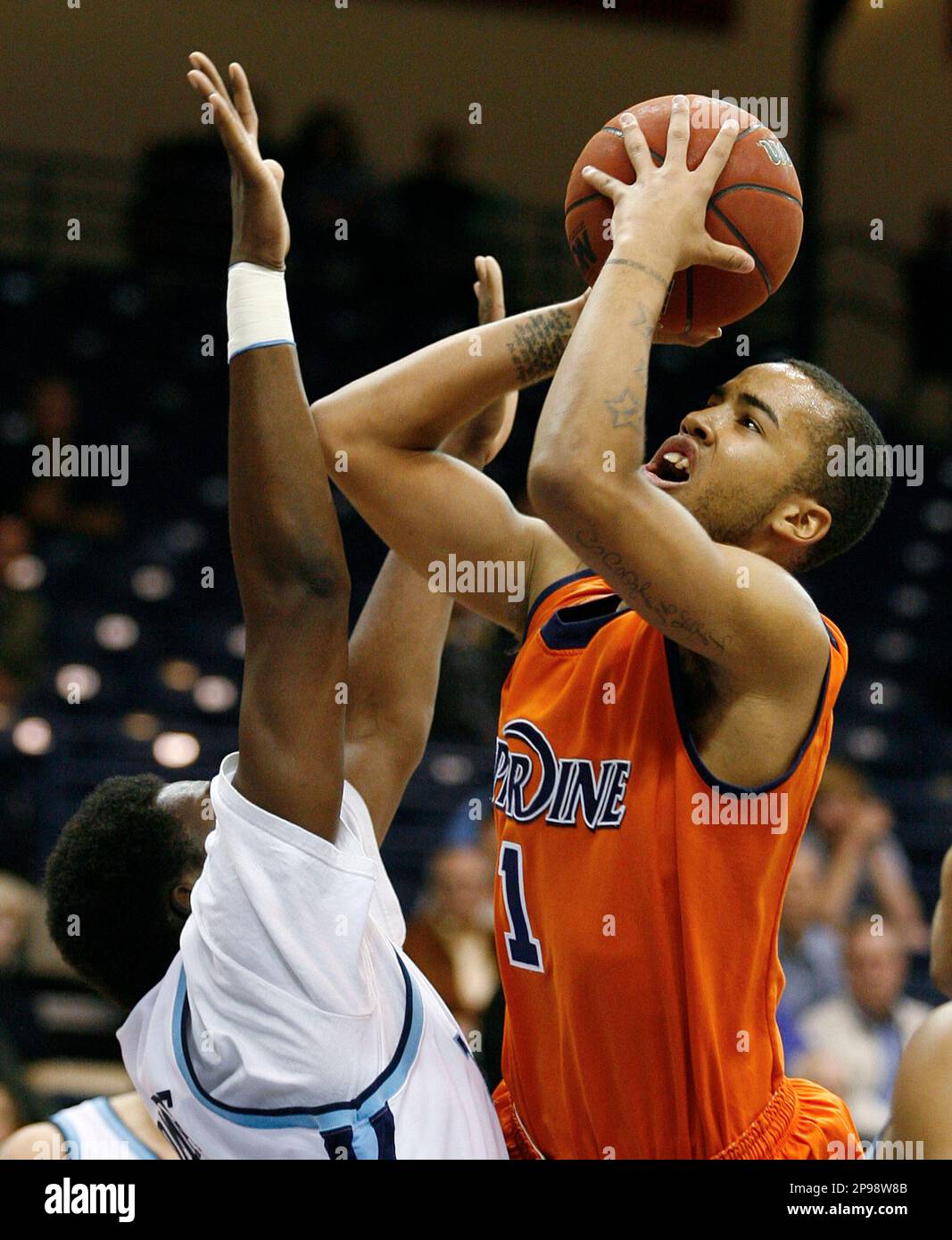 Pepperdine's Dane Suttle, right, shoots over the attempted block of San ...