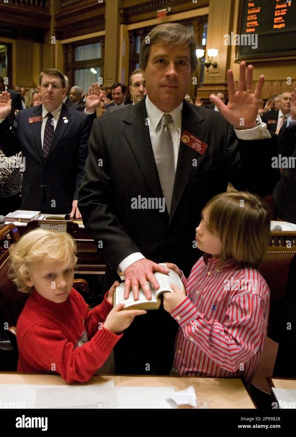 Rep. Greg Morris, R-Vidalia, is sworn in as his sons Jonathan, 6, left ...