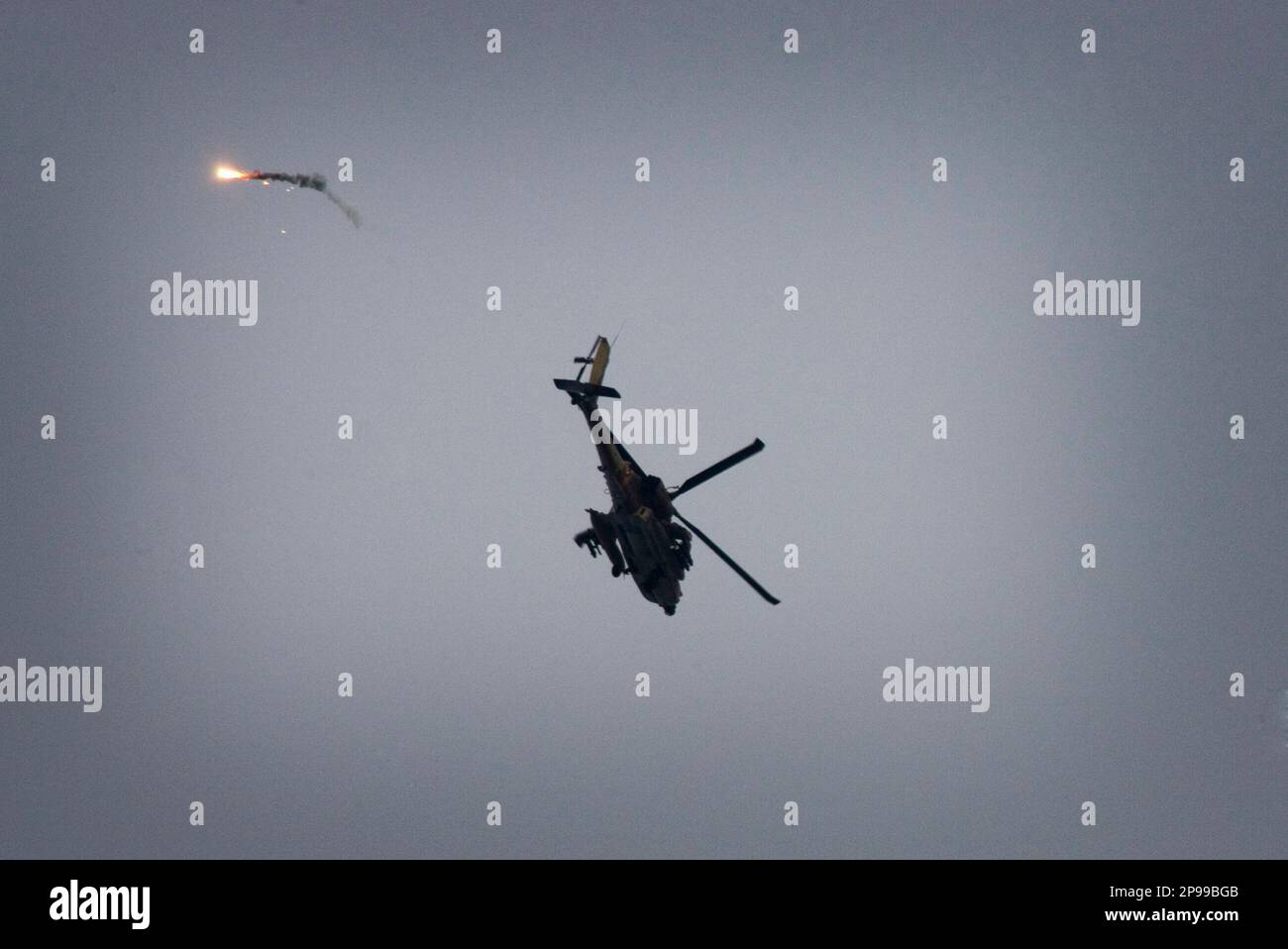 An Israeli attack helicopter fires flares as he operates over the Gaza ...