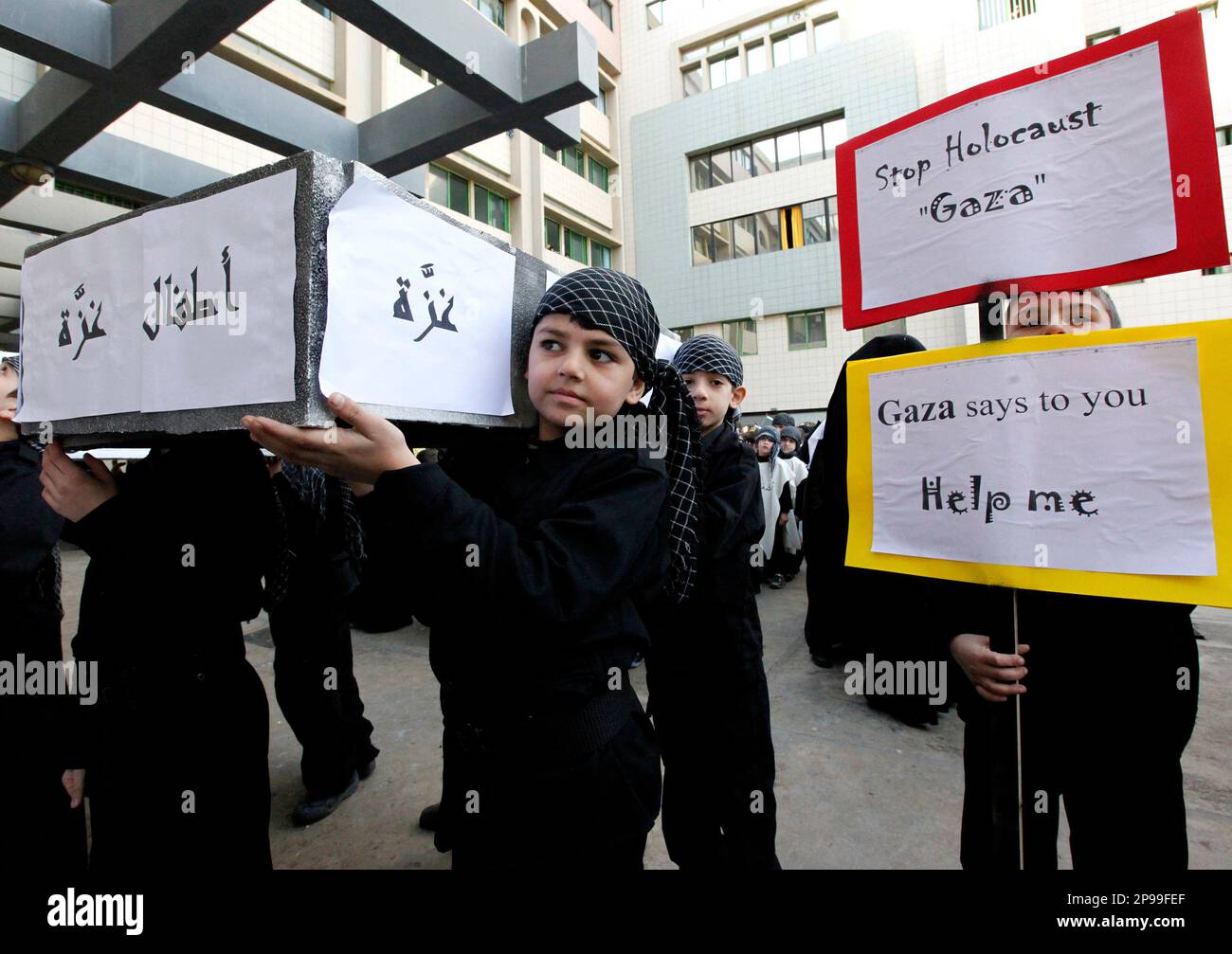 Lebanese Hezbollah student supporters carry a mock coffin readin in ...