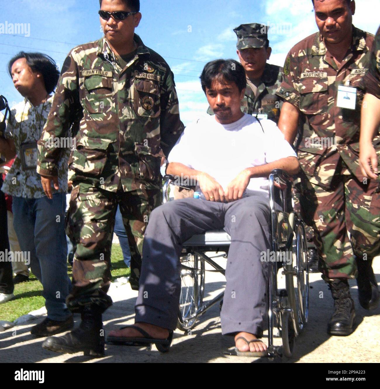 Philippine Army Lt. Vicente Cammayo, center, is push on a wheelchair to an ambulance after his ...