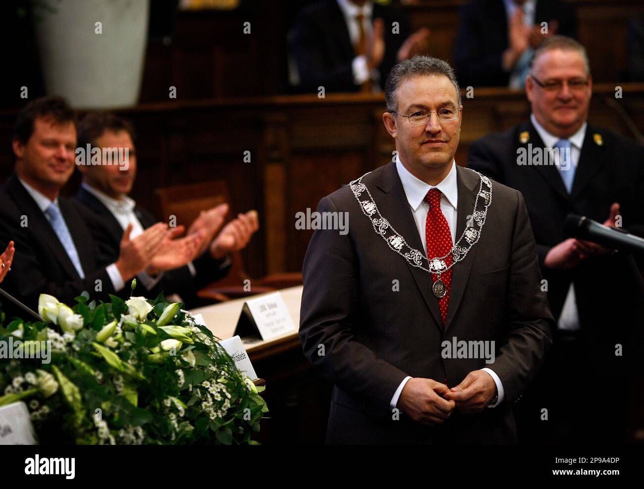Moroccan-born immigrant Ahmed Aboutaleb, center, wears the chain of ...