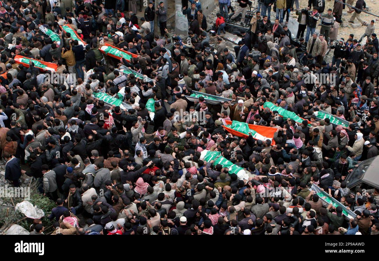 Palestinians carry 14 bodies during the funeral procession for Hamas ...