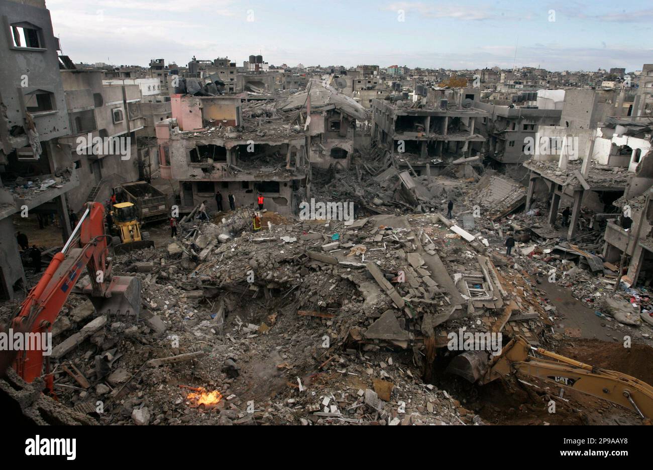 Palestinian firefighters work in the rubble of senior Hamas militant ...