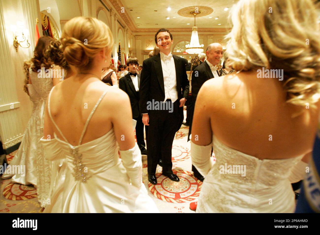 Debutantes greet a guest in the receiving line during the 54th ...