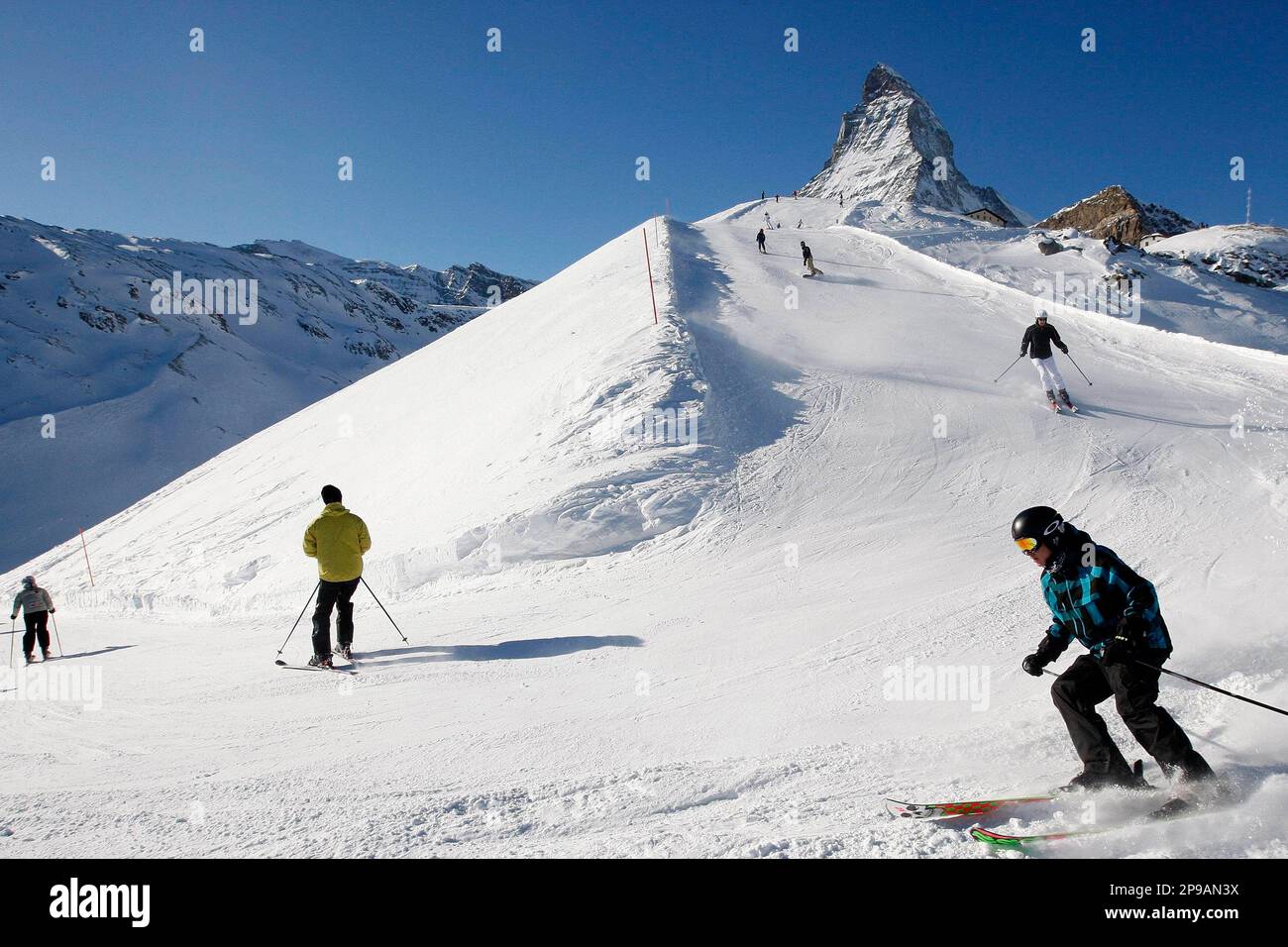 Skiers and snowboarders enjoy the perfect conditions, in front of the ...