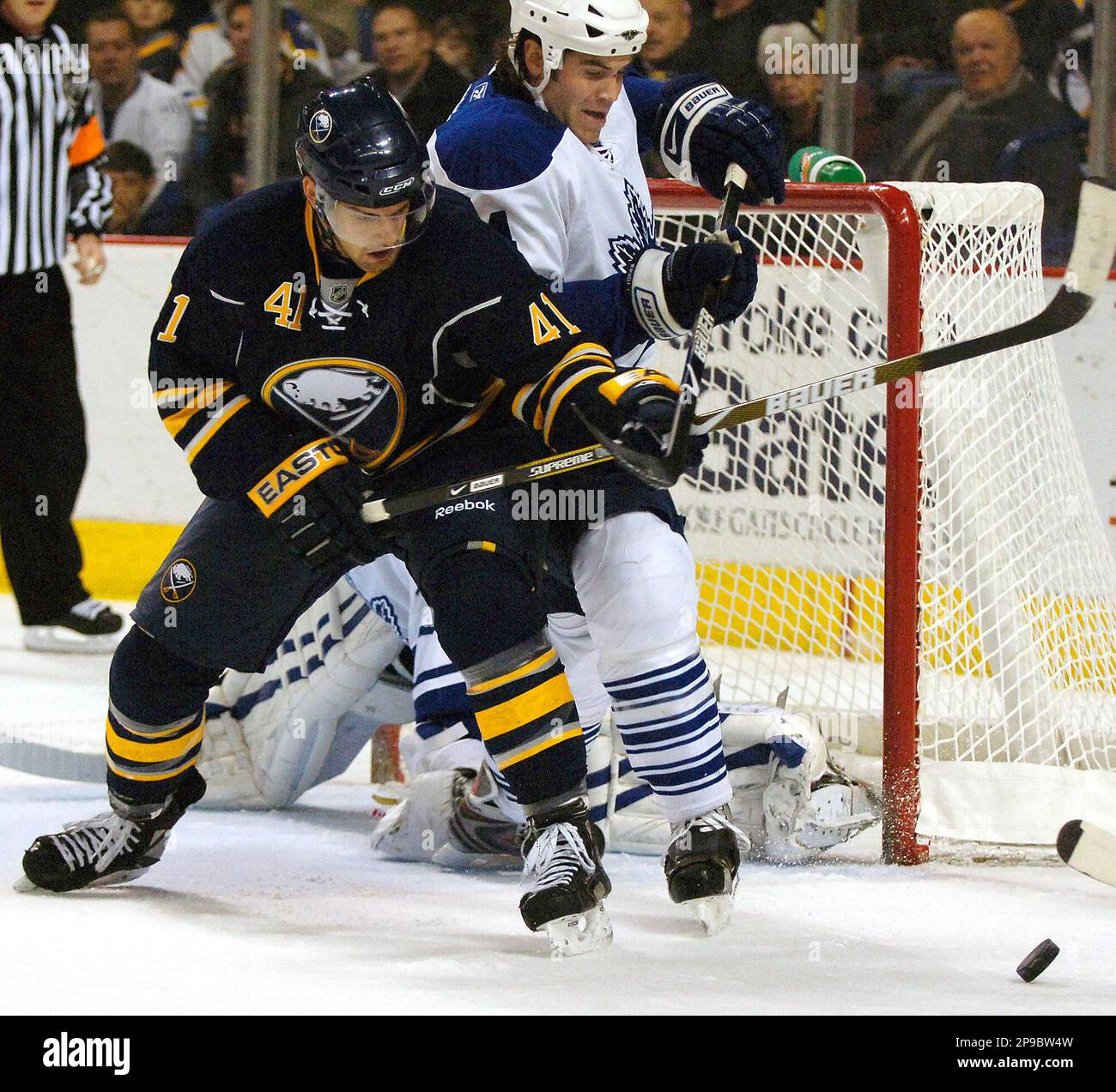 Buffalo Sabres left winger Clarke MacArthur, left, is checked by ...