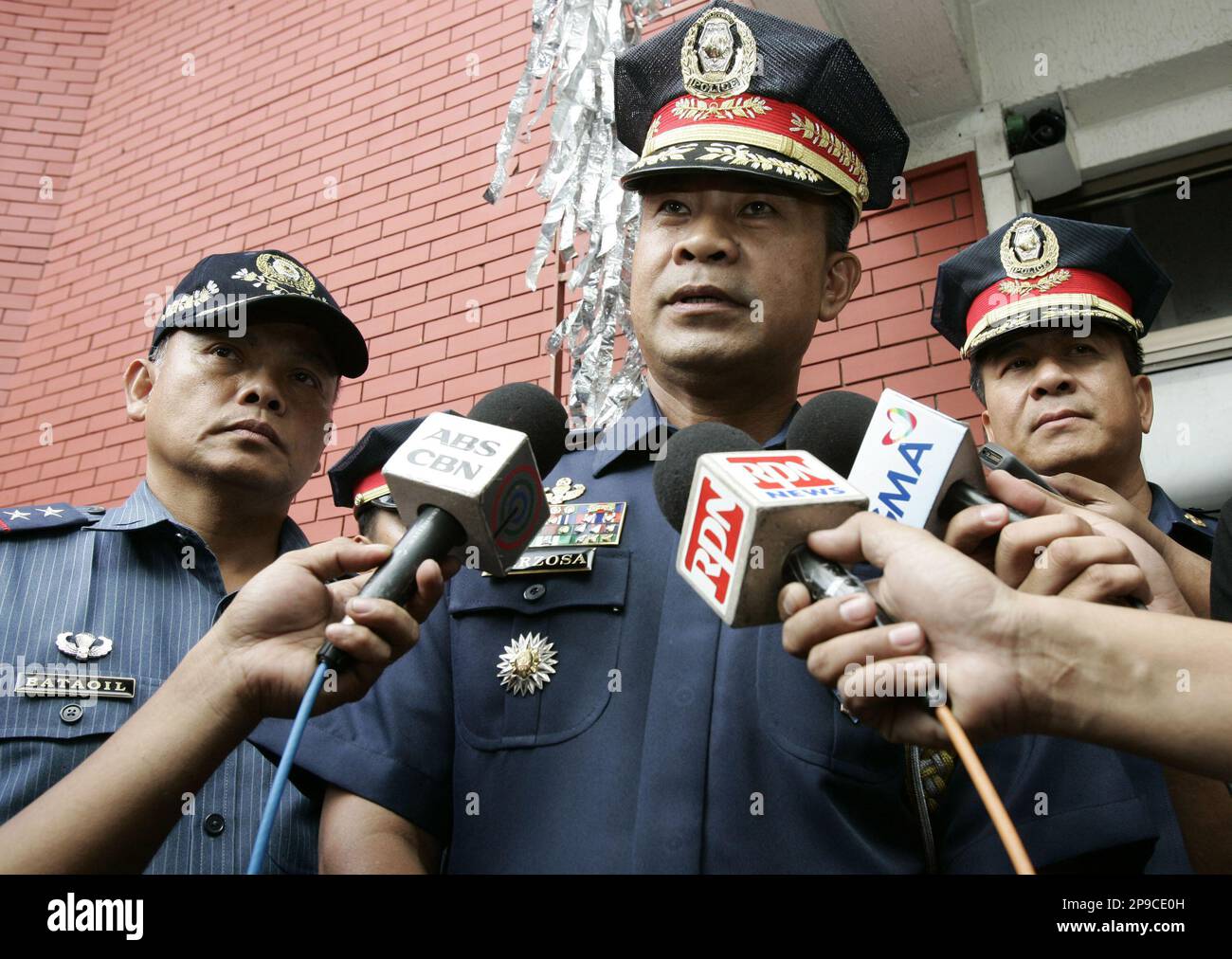 Philippine National Police Chief Jesus Verzosa, center, talks to the ...
