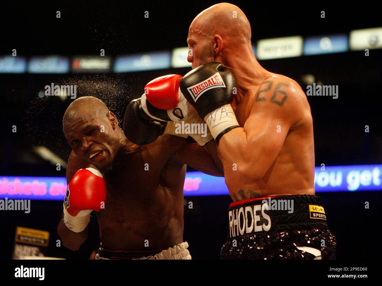 British middleweight Ryan Rhodes, right, is hit by a punch from South ...