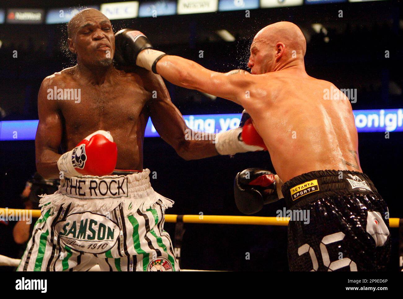 British middleweight Ryan Rhodes, right, is hit by a punch from South ...