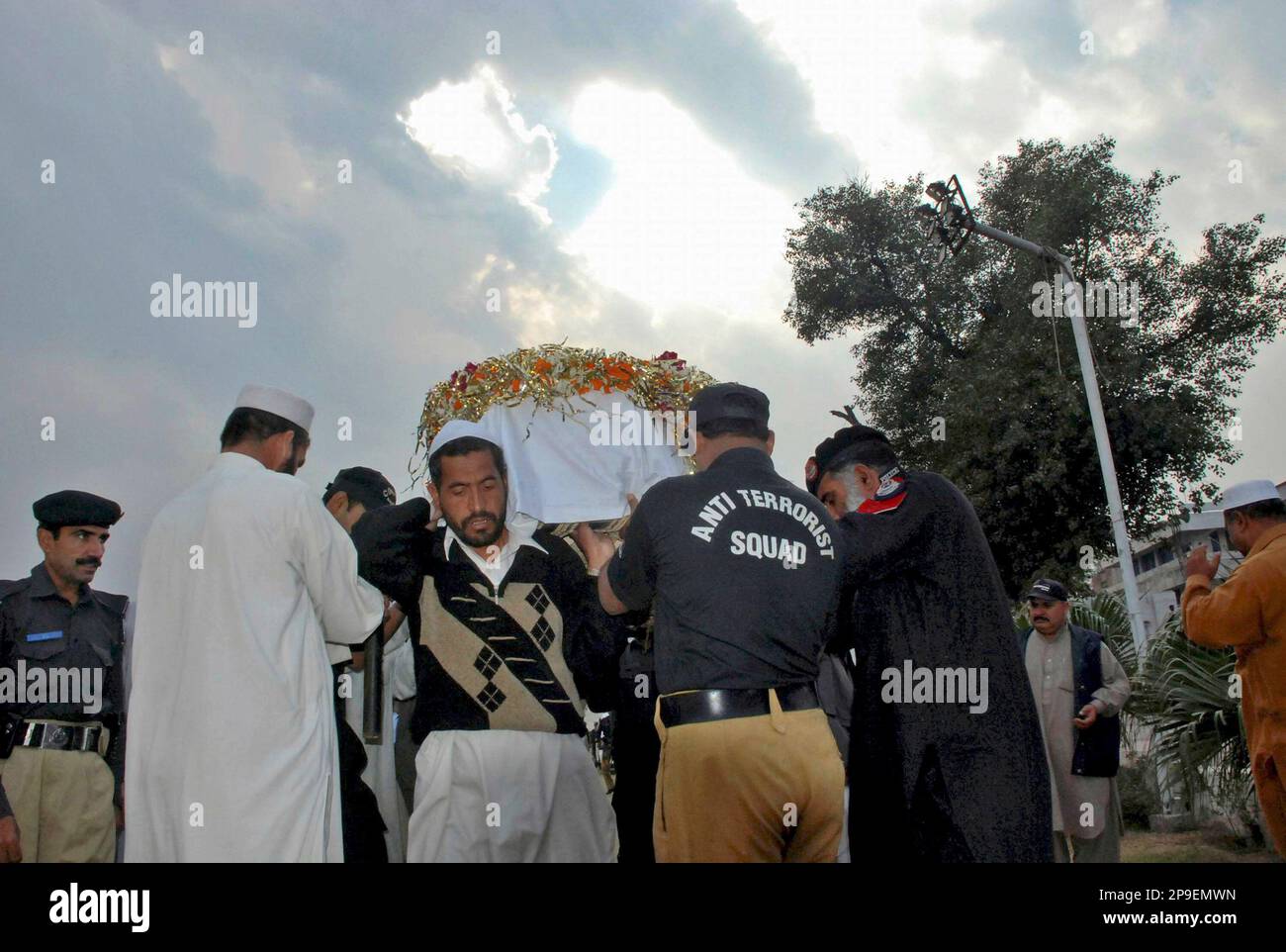 Pakistani police officers carry the coffin containing their colleague's ...