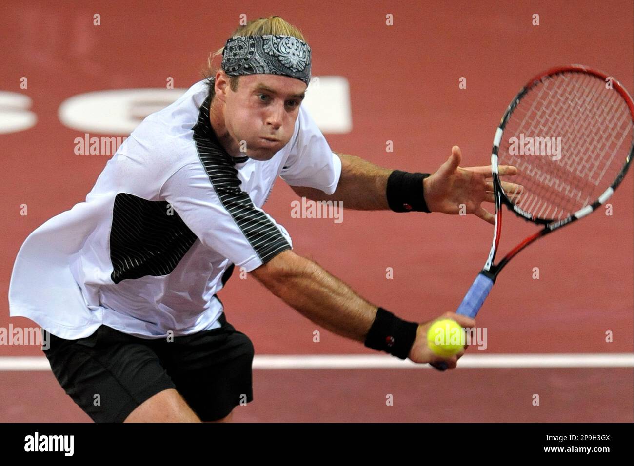 Switzerland's George Bastl returns a ball to Argentina's Juan Martin ...